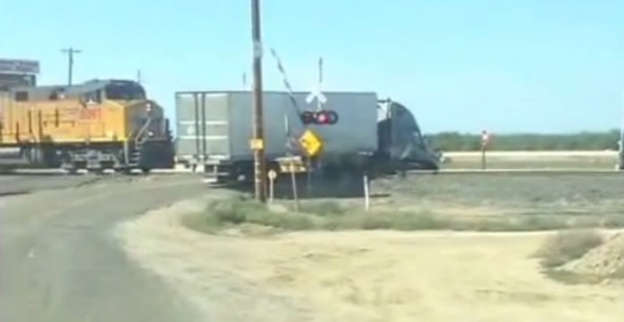 Semi Truck Stranded on Train Tracks, Explodes Trail Mix