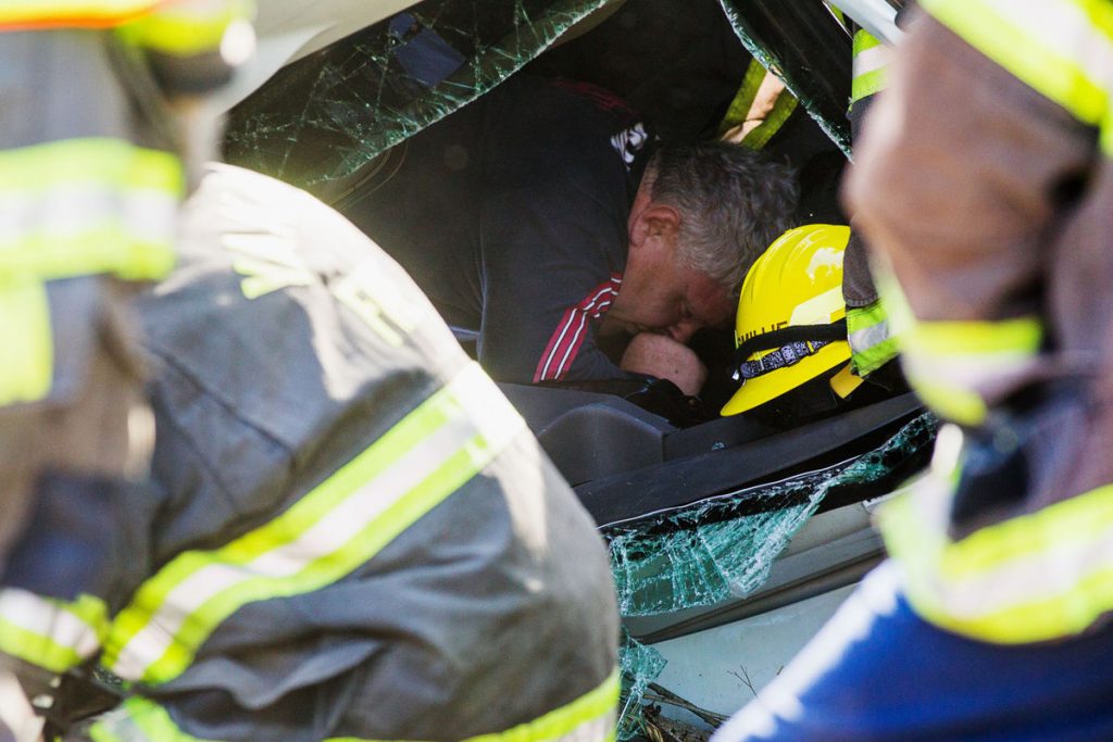 Truck driver was pinned inside cab for more than an hour after taking ...