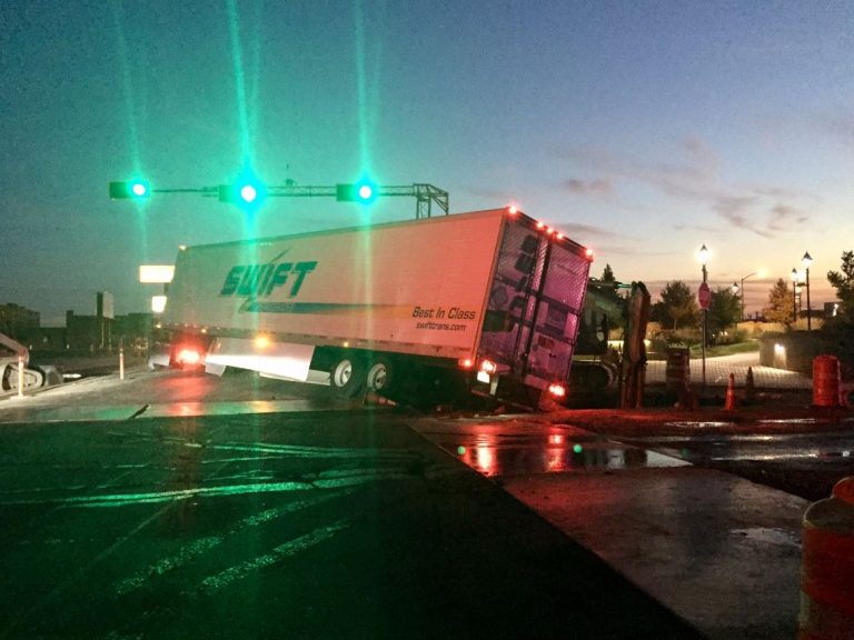 Tractor trailer gets stuck after taking turn too tight, shuts down ...